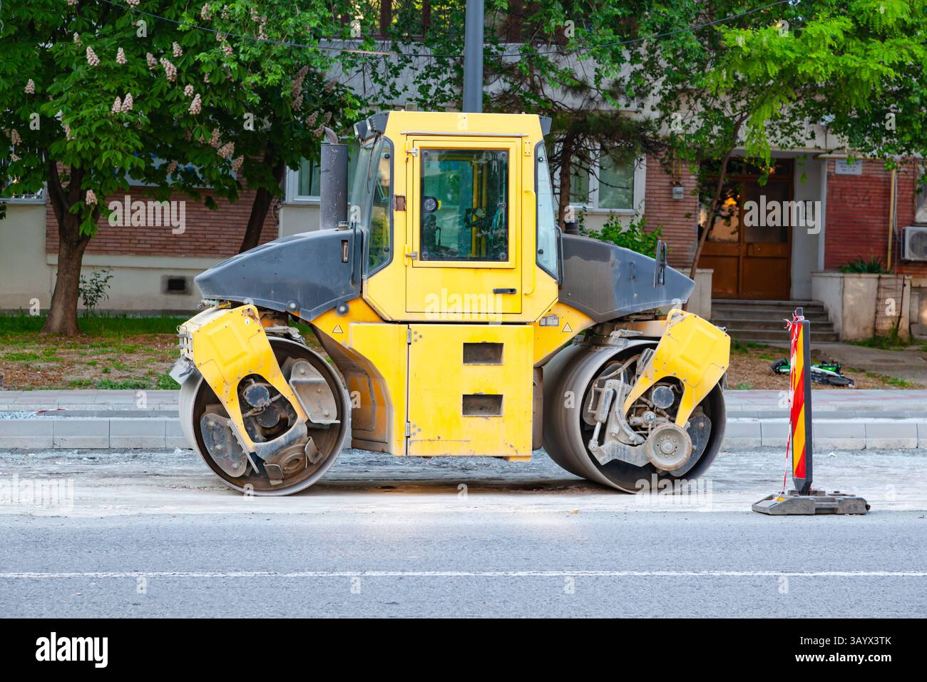 A road asphalt rolling machine standing on a road in the city Stock ...