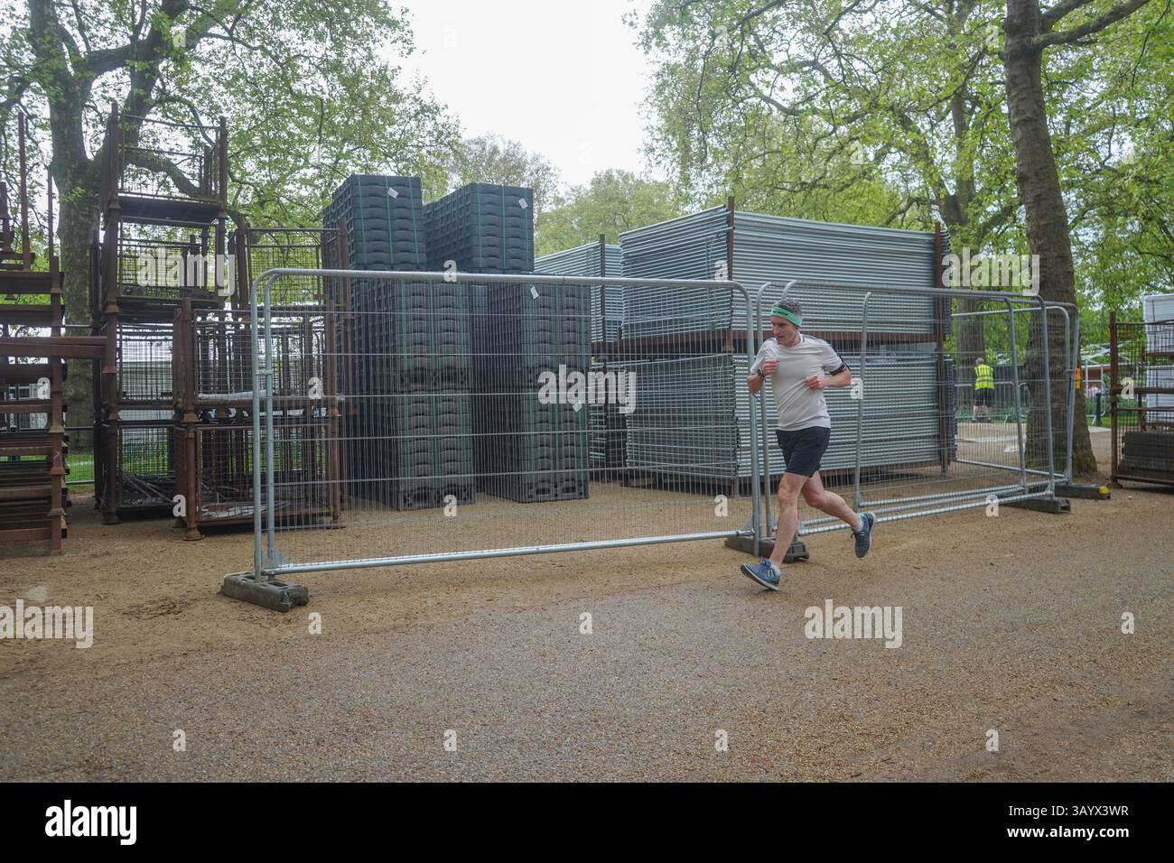 London UK 23 April 2025. A jogger runs past security barriers and ...