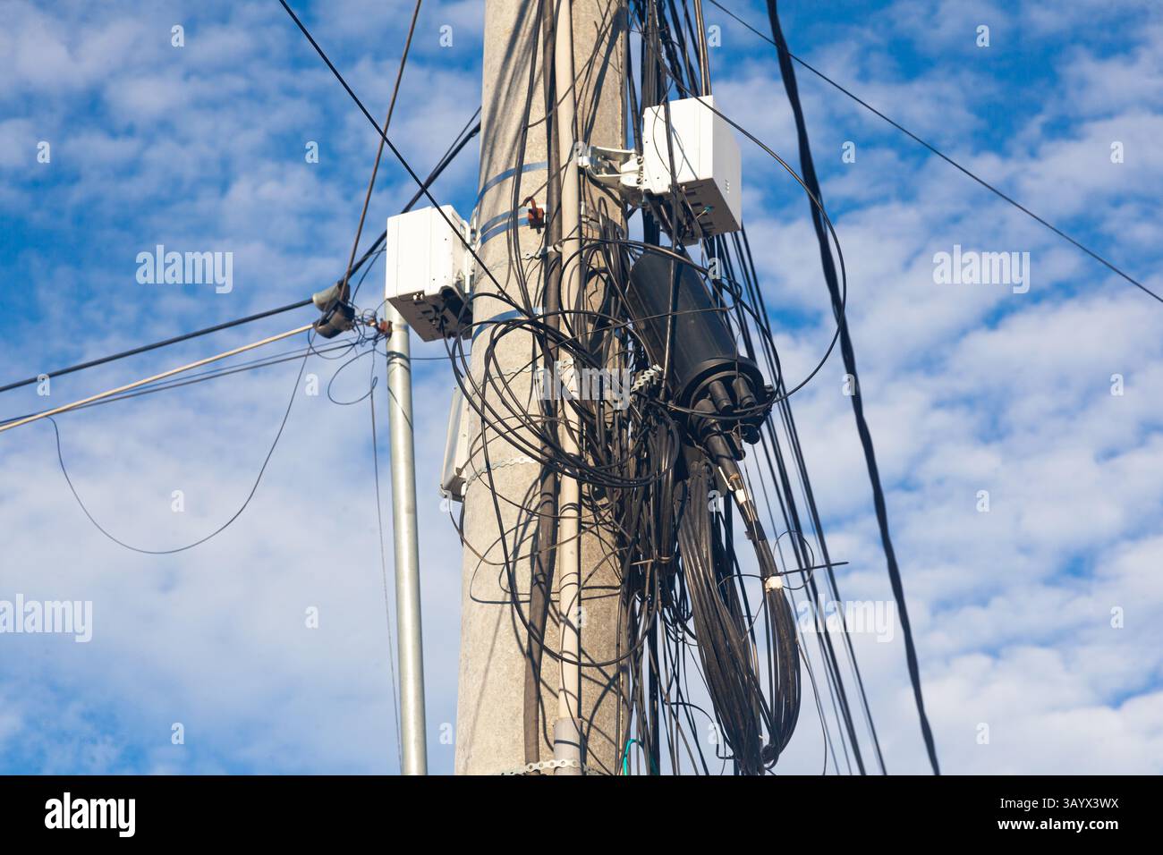 A pole with electric cables against the sky Stock Photo - Alamy