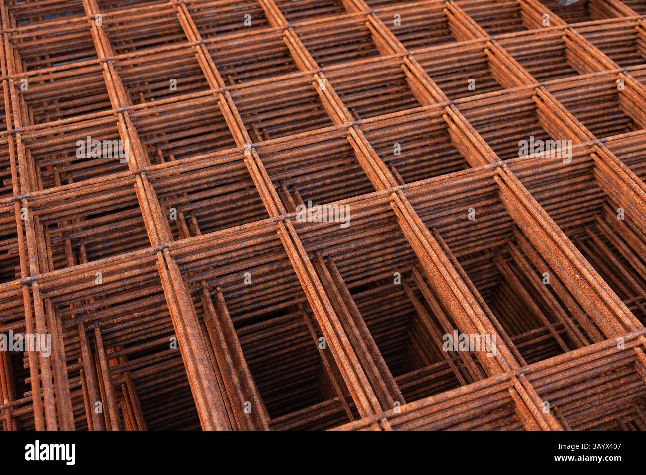 Welded, rusty, steel reinforcement is laid one on top of the other ...