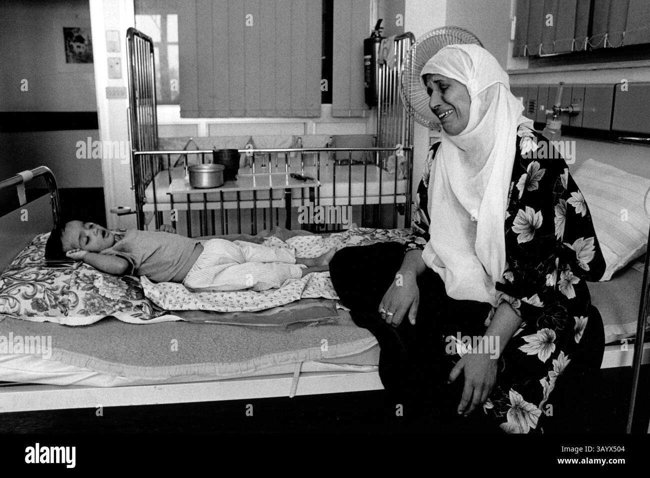 Chador. An Iraqi Woman Cares For Her Baby Son At Saddam Hussein ...