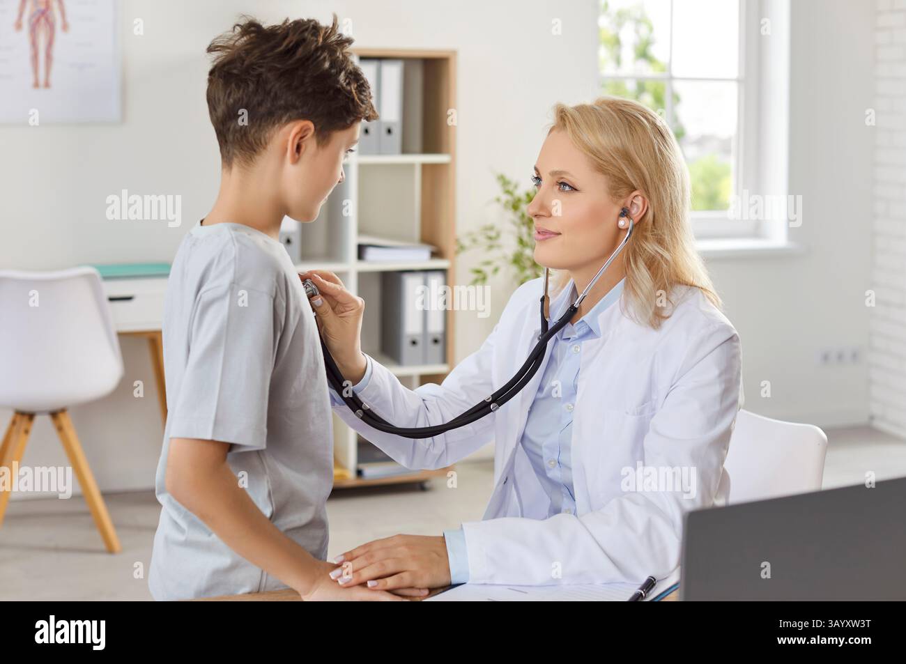 Positive Doctor Checking Schoolboy Patient Breathing With Stethoscope ...