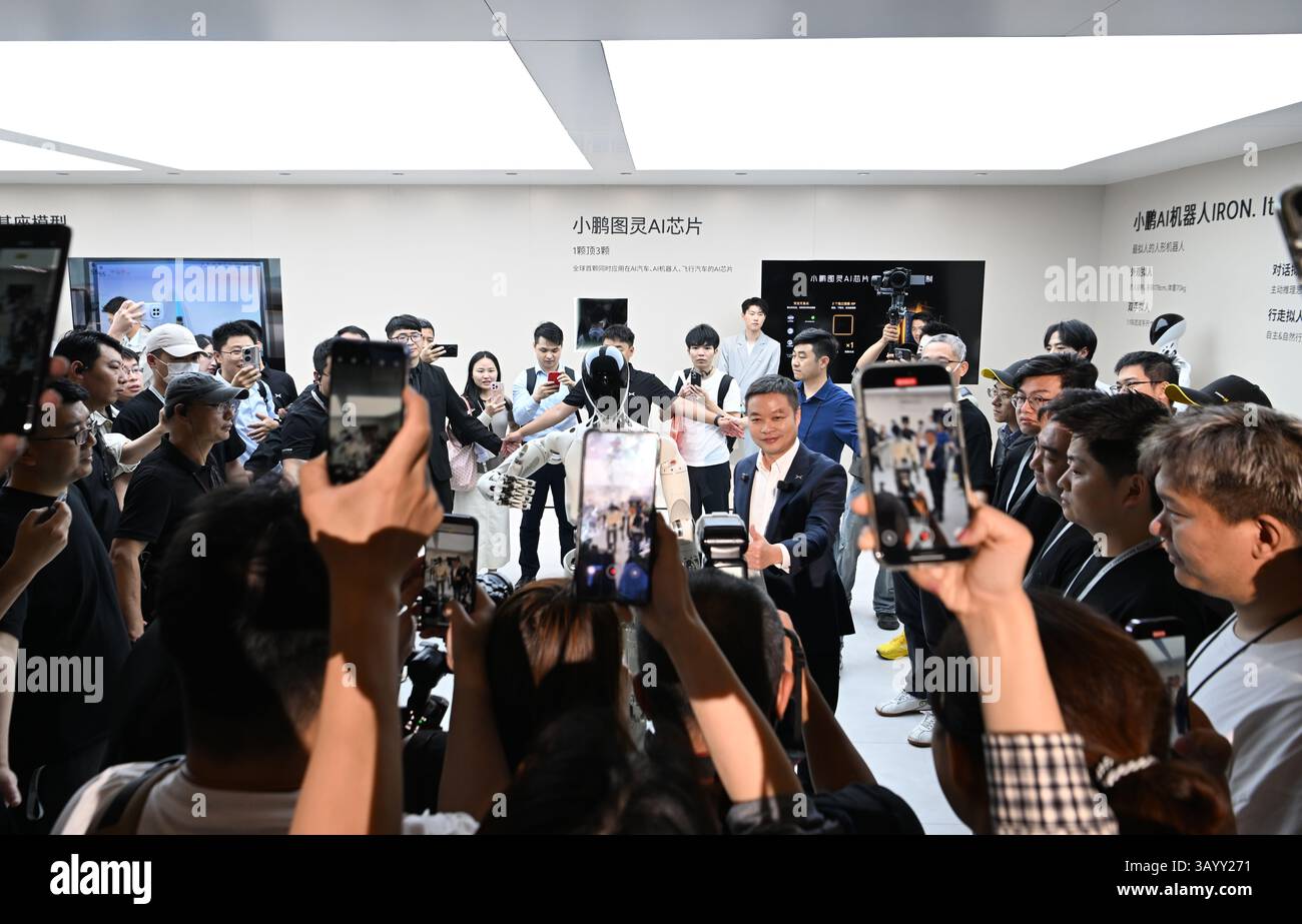 He Xiaopeng, the chairman of Xpeng Motors, interacted with the robot IRON at the 2025 Shanghai ...