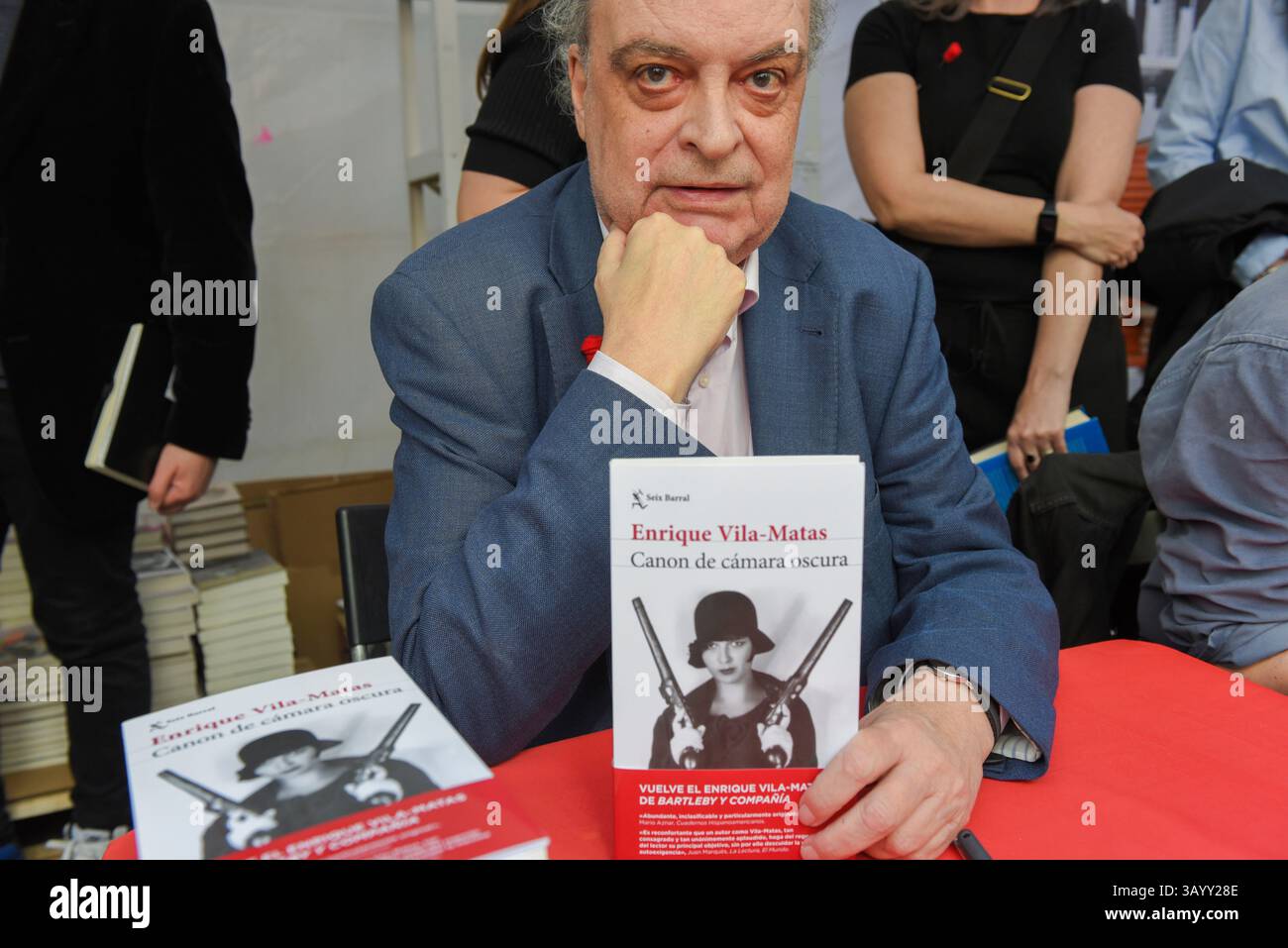 The writer Enrique Vila-Matas poses with one of his copies, on the ...