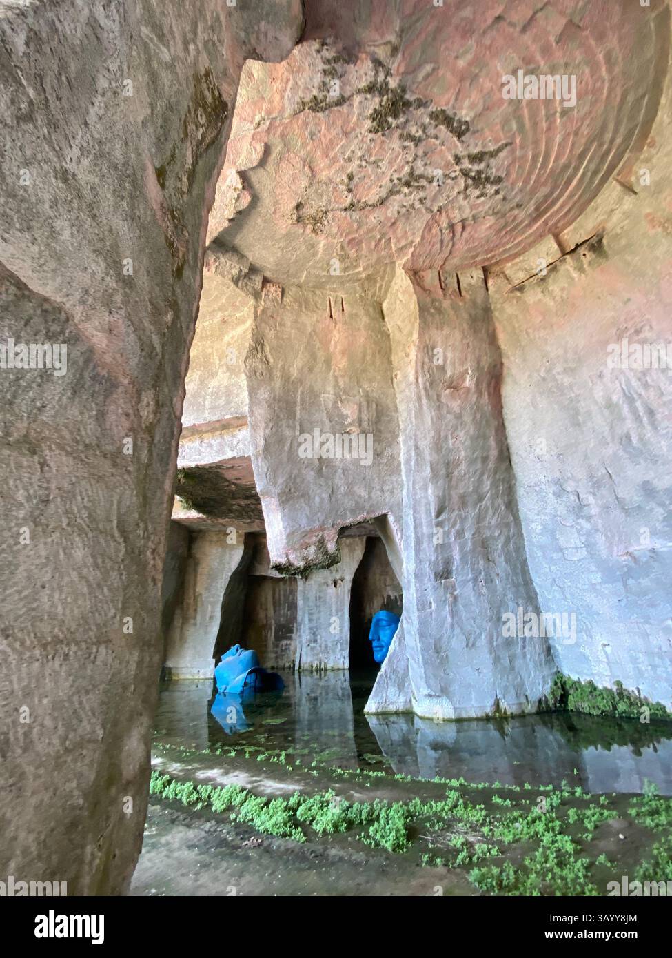Limestone cave featuring pink stone walls and enigmatic blue human ...