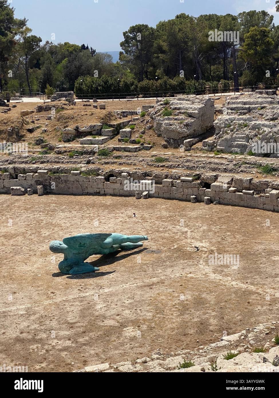 Broken Icarus sculpture resting on dramatic stage within Neapolis ...