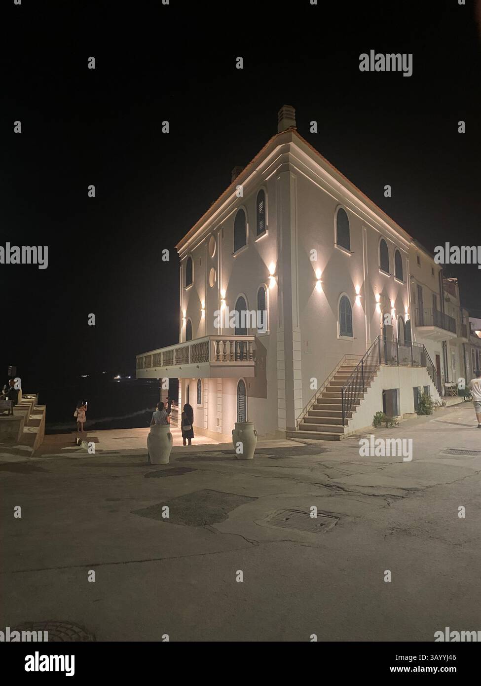 Low-angle nighttime view of illuminated white architecture standing ...