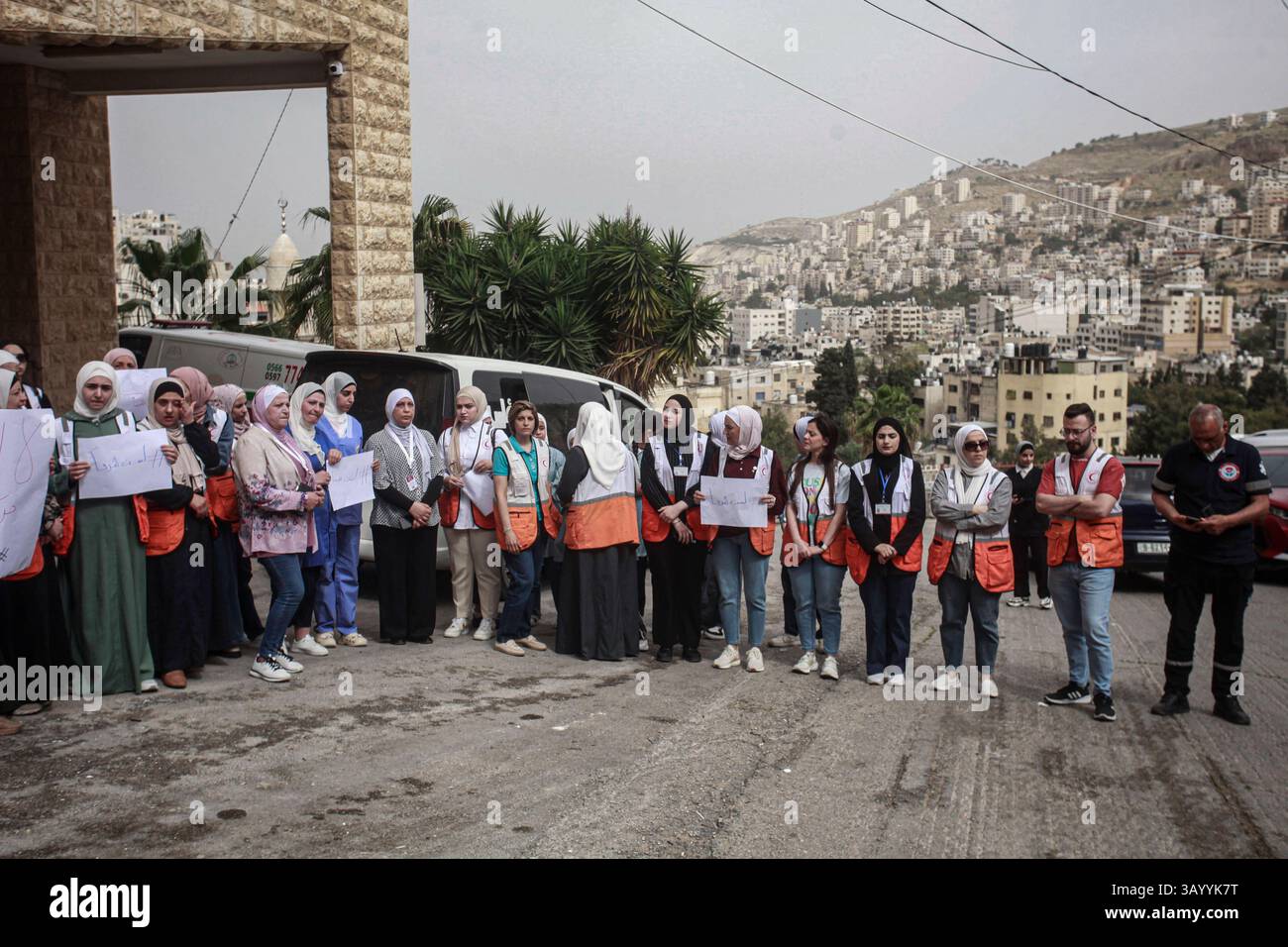Palestinian Red Crescent Society paramedics hold banners in honor of ...