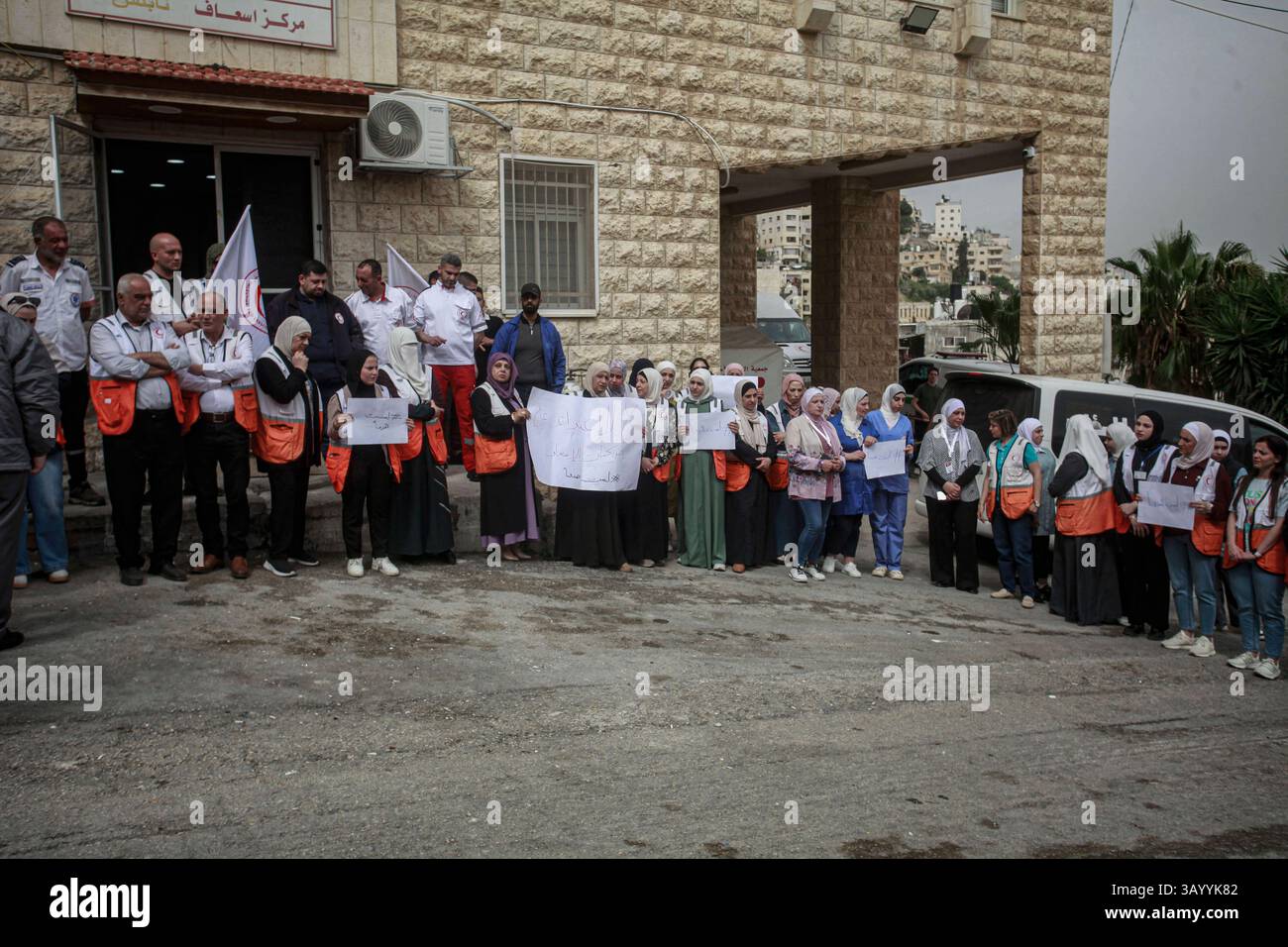 Palestinian Red Crescent Society paramedics hold banners in honor of ...