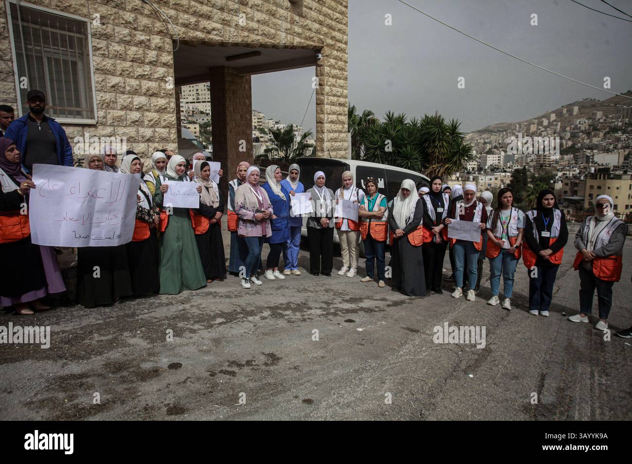 Palestinian Red Crescent Society paramedics hold banners in honor of ...