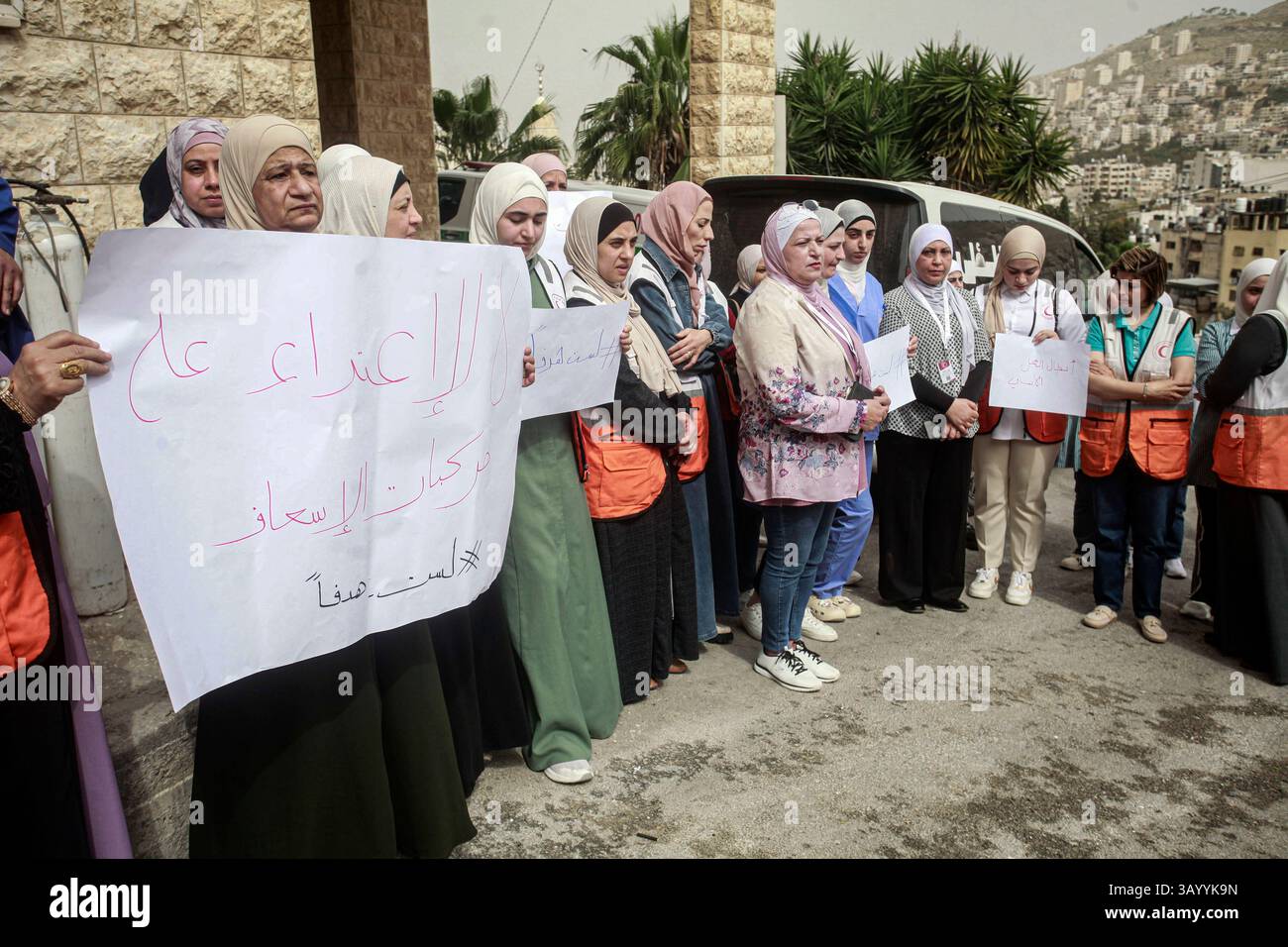 Palestinian Red Crescent Society paramedics hold banners in honor of ...