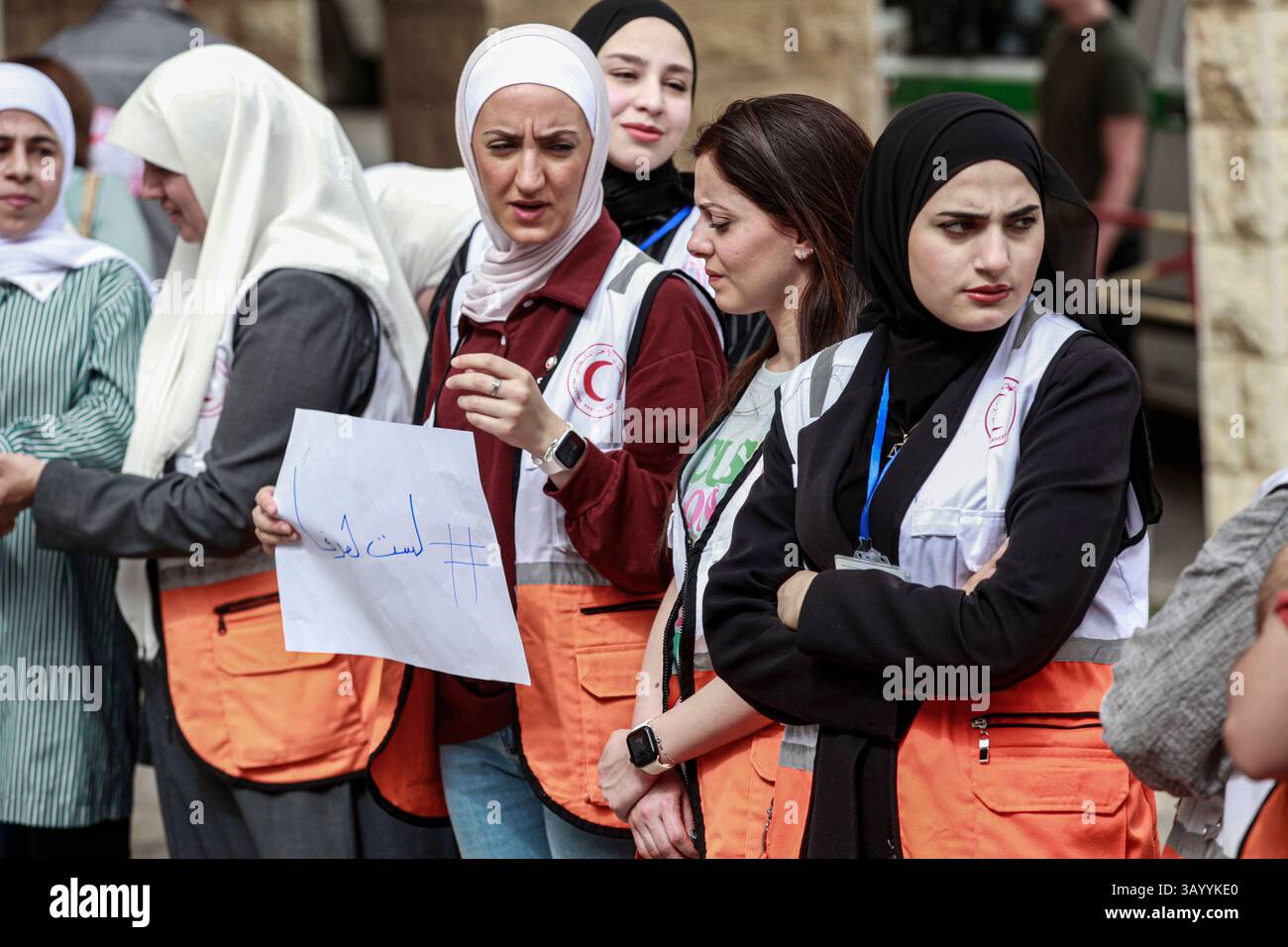 Palestinian Red Crescent Society paramedics hold banners in honor of ...