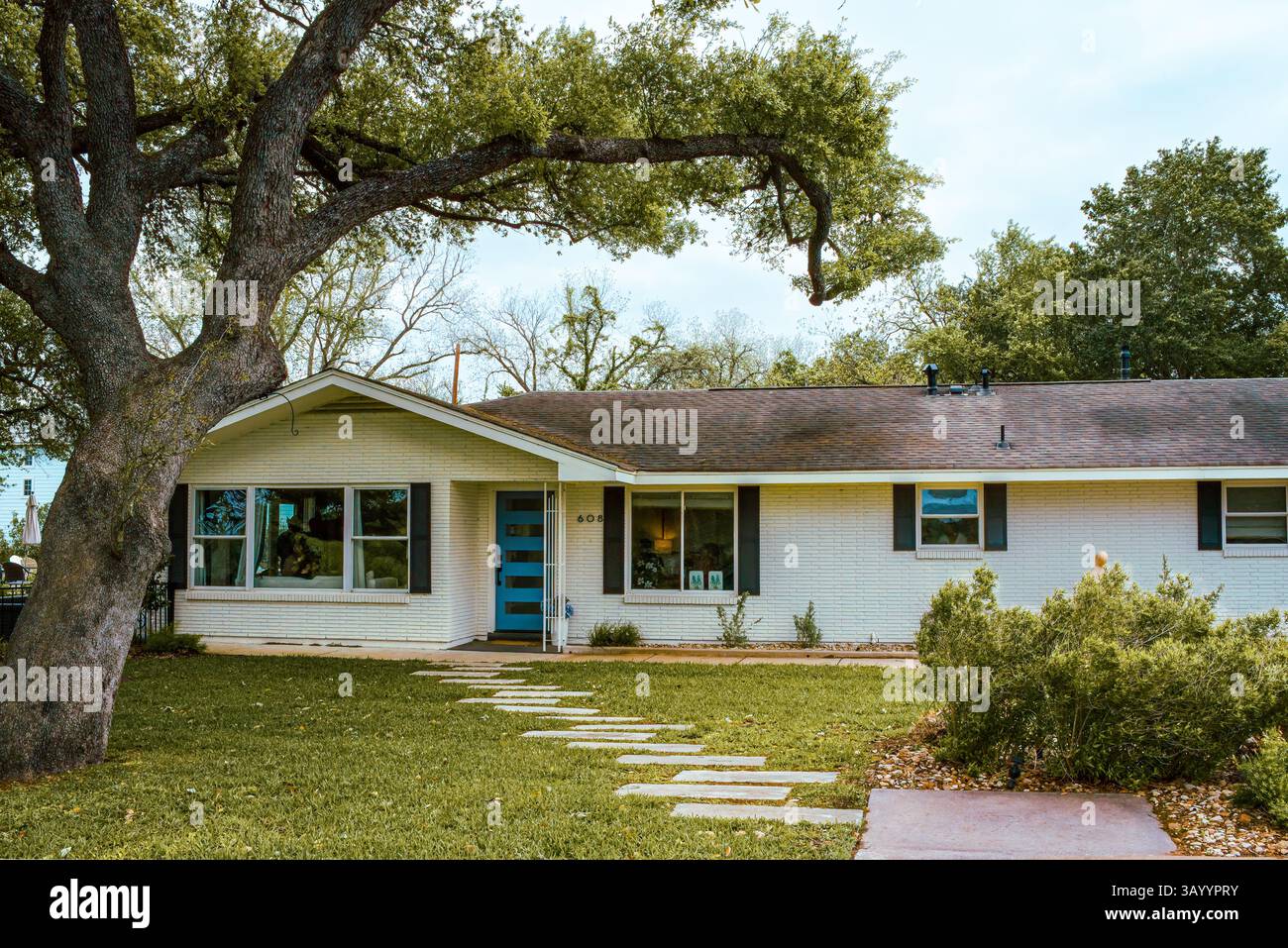 Simple, modern white one story house rented out as an Air B&B ...