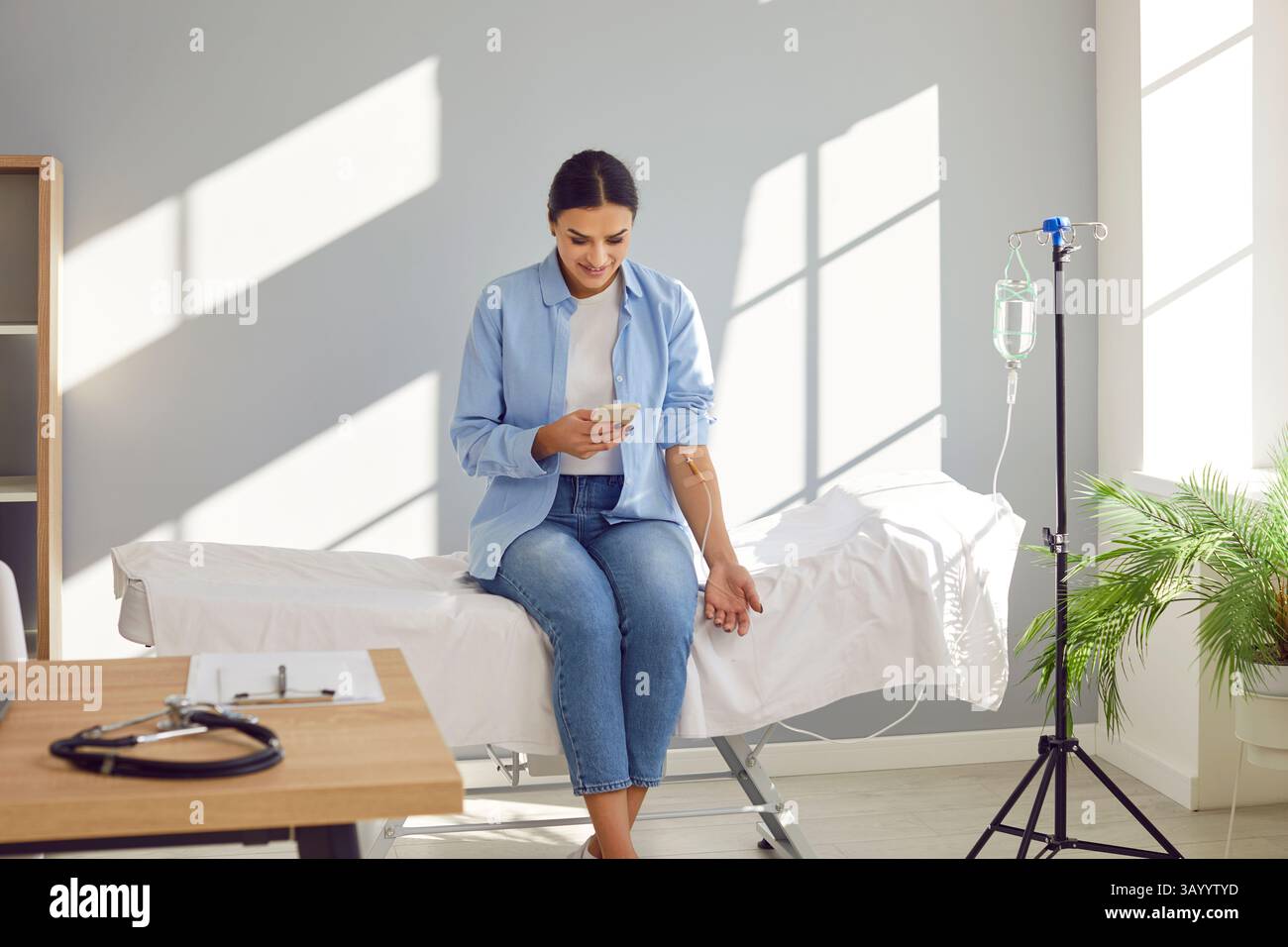 Positive Woman Receiving IV Drip Therapy in Hospital Office Stock Photo ...
