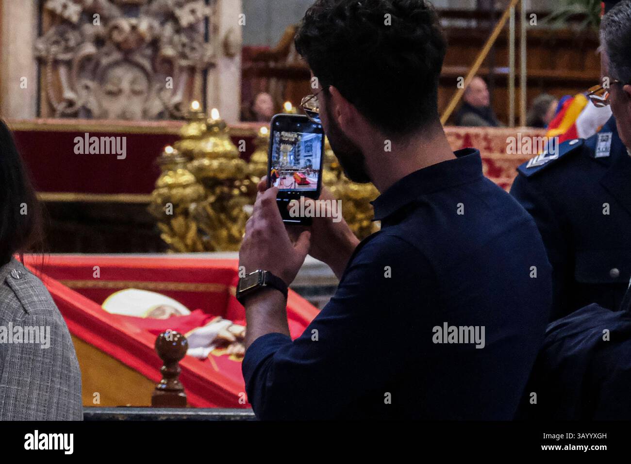 A faithful takes a mobile phone photo of the body of Pope Francis lying ...