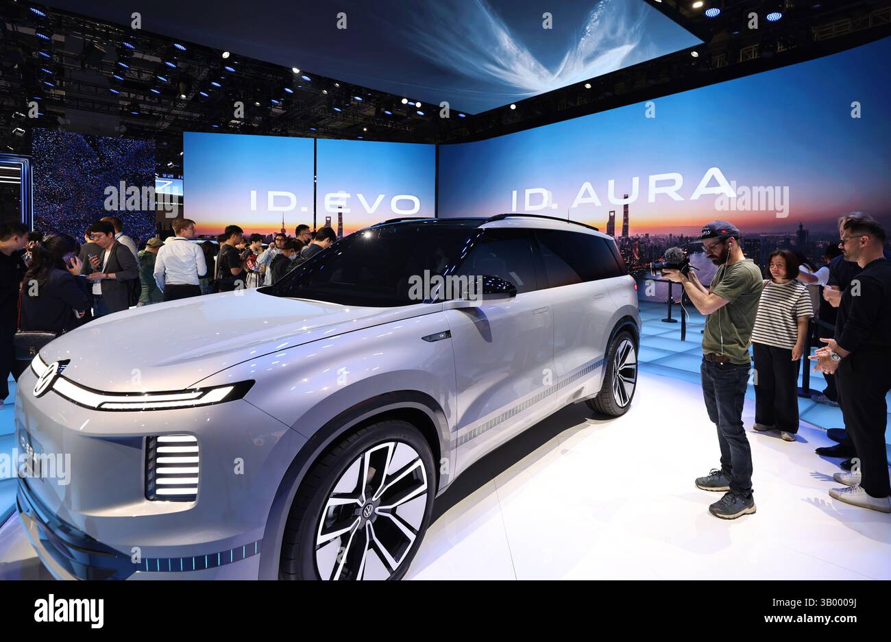 Shanghai. 23rd Apr, 2025. A journalist records a Volkswagen ID.AURA on ...