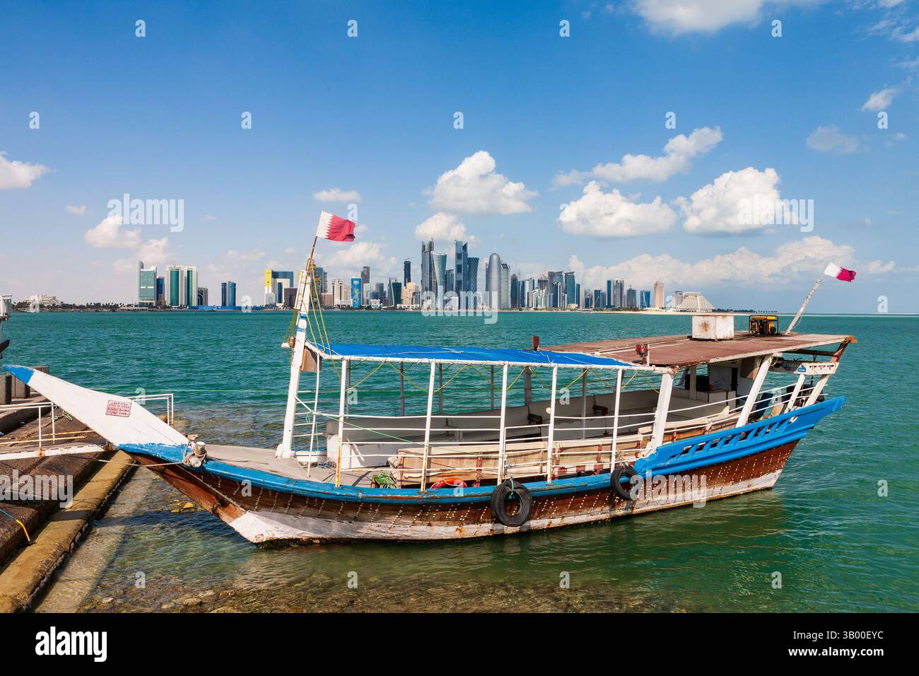 Day time Doha city view, Arabic traditional cruise dhow boat docked at ...