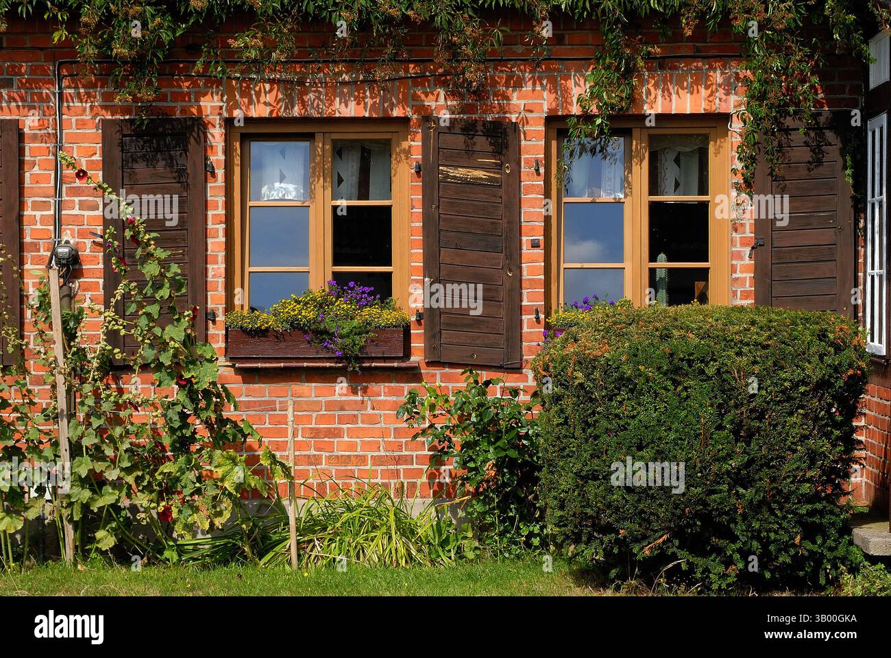 Charm with romantic windows and garden Stock Photo - Alamy