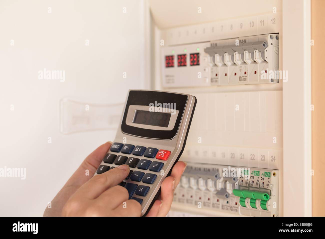 Calculating Home Electricity Bill. Woman calculating electricity usage with calculator near ...