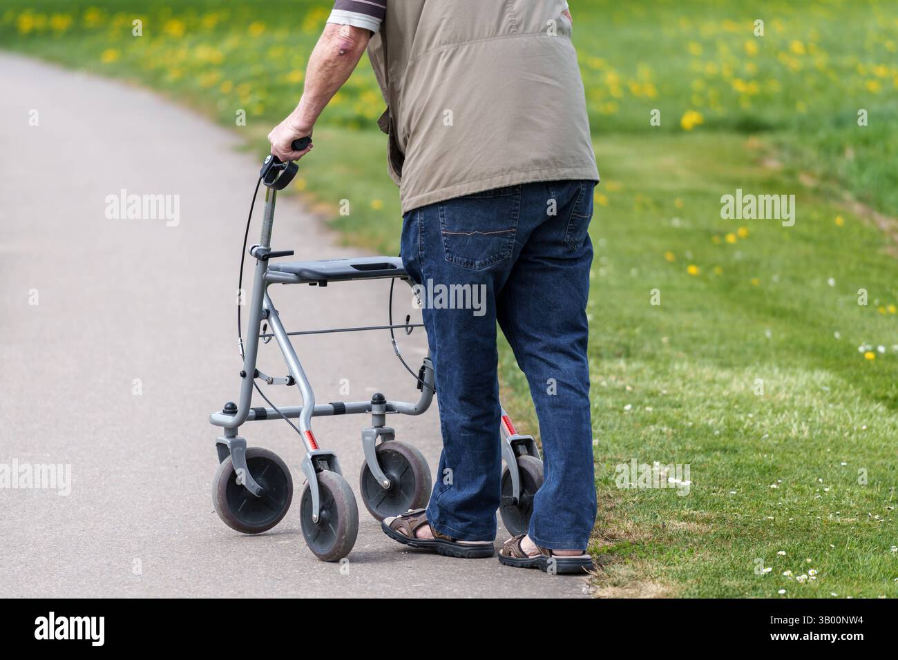 Bavaria, Germany - April 20, 2025: An elderly man walks with a walker ...