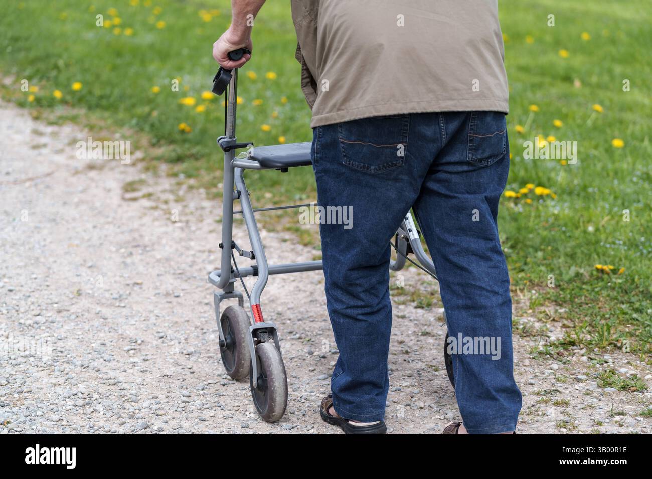 Bavaria, Germany - April 20, 2025: An elderly man walks with a walker ...
