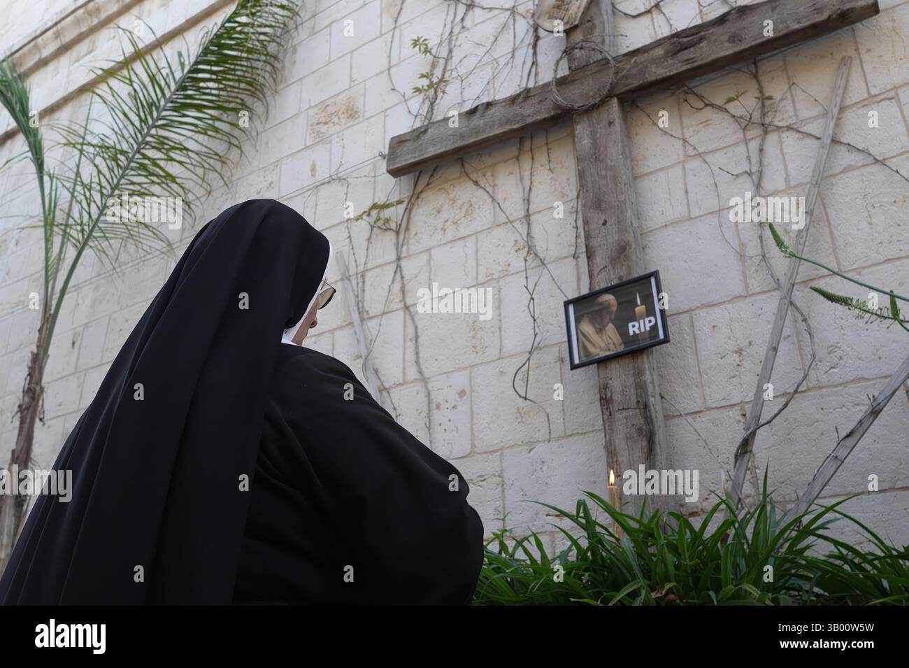 ERUSALEM - APRIL 21: A catholic nun pays her respect in front of a ...