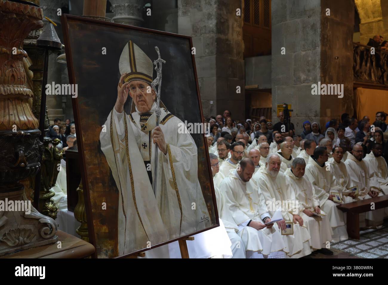 JERUSALEM - APRIL 23: Roman Catholic clergymen sit by a portrait of ...