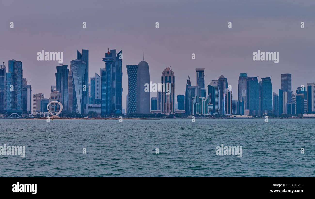 Doha Qatar skyline from corniche promenade sunset shot showing dhows in ...