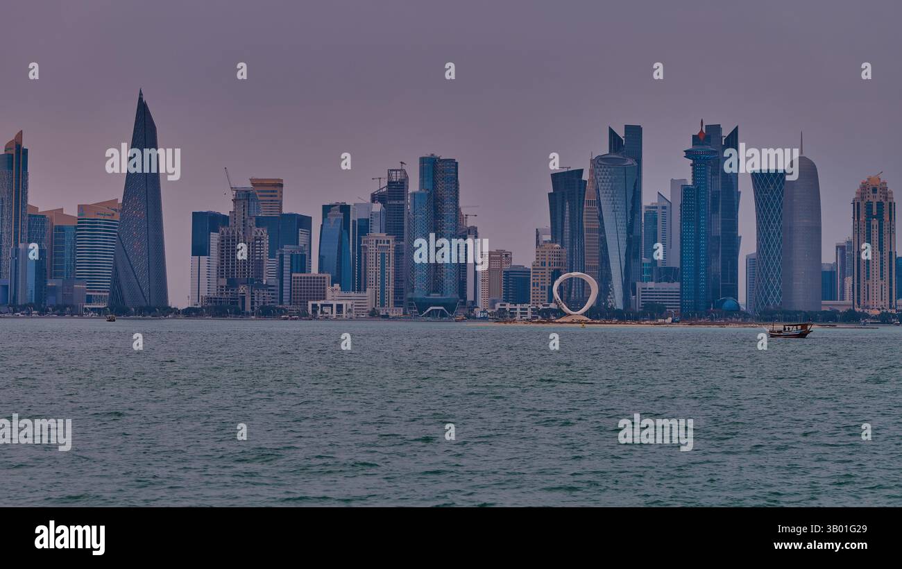 Doha Qatar skyline from corniche promenade sunset shot showing dhows in ...