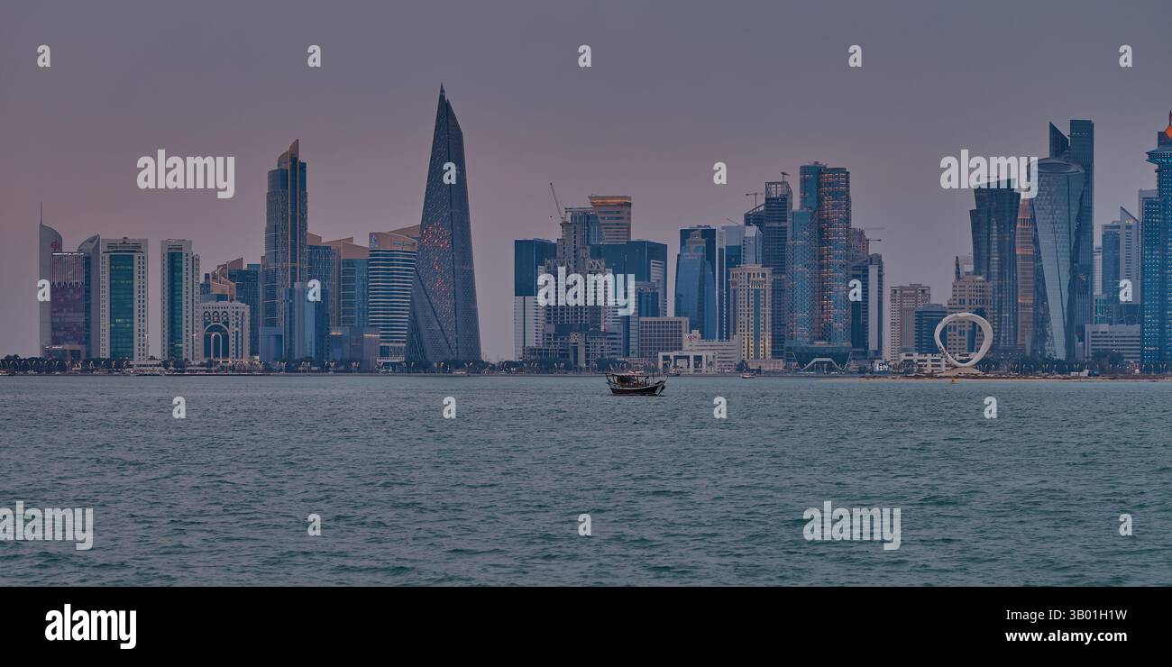 Doha Qatar skyline from corniche promenade sunset shot showing dhows in ...