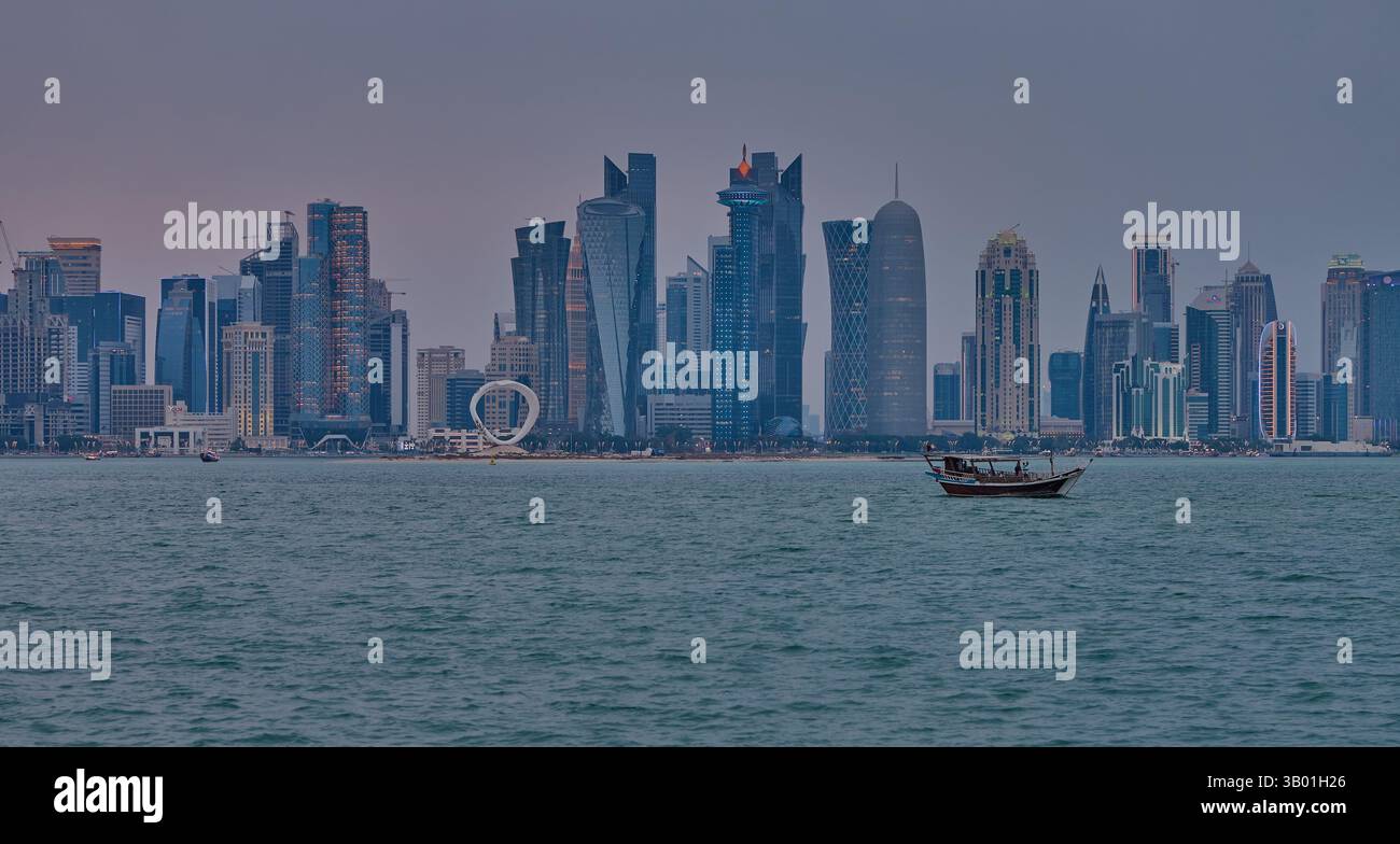 Doha Qatar skyline from corniche promenade sunset shot showing dhows in ...