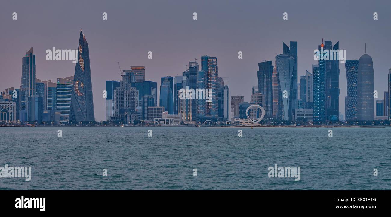 Doha Qatar skyline from corniche promenade sunset shot showing dhows in ...