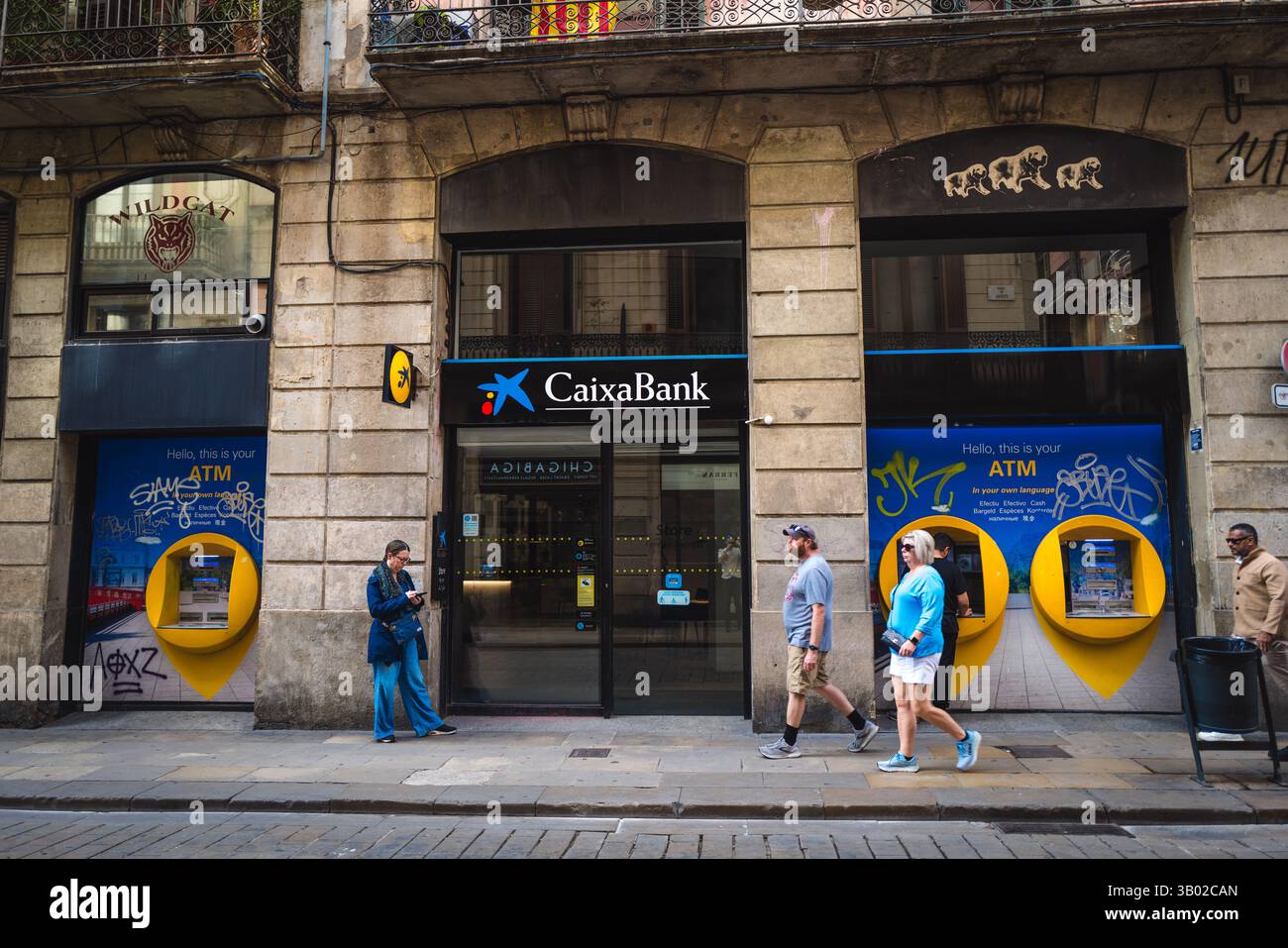 Image of a bank and its ATM with people walking down the street Stock ...