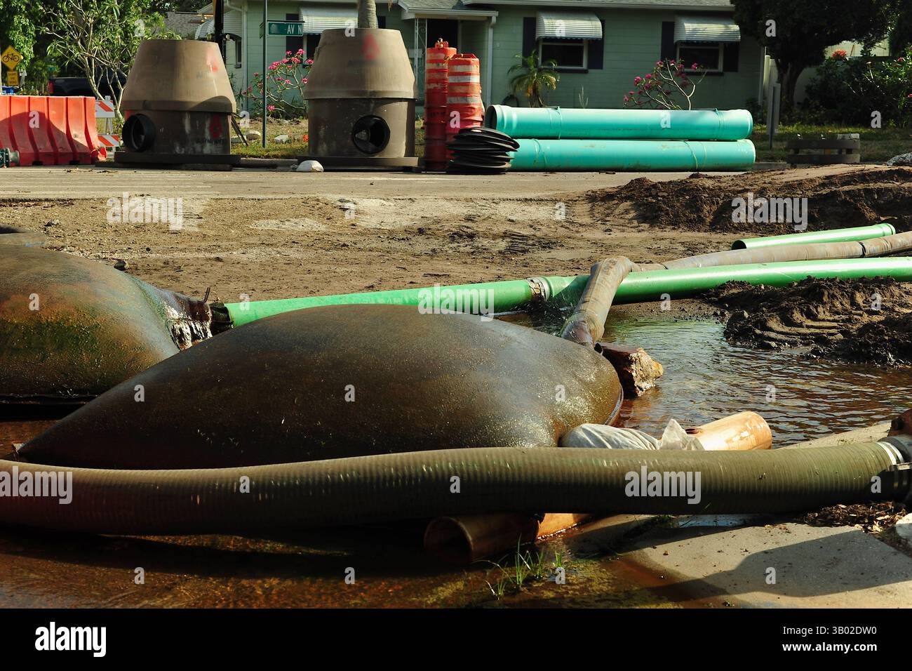 Black dewatering bag attach to the ends of discharge pipes to catch ...