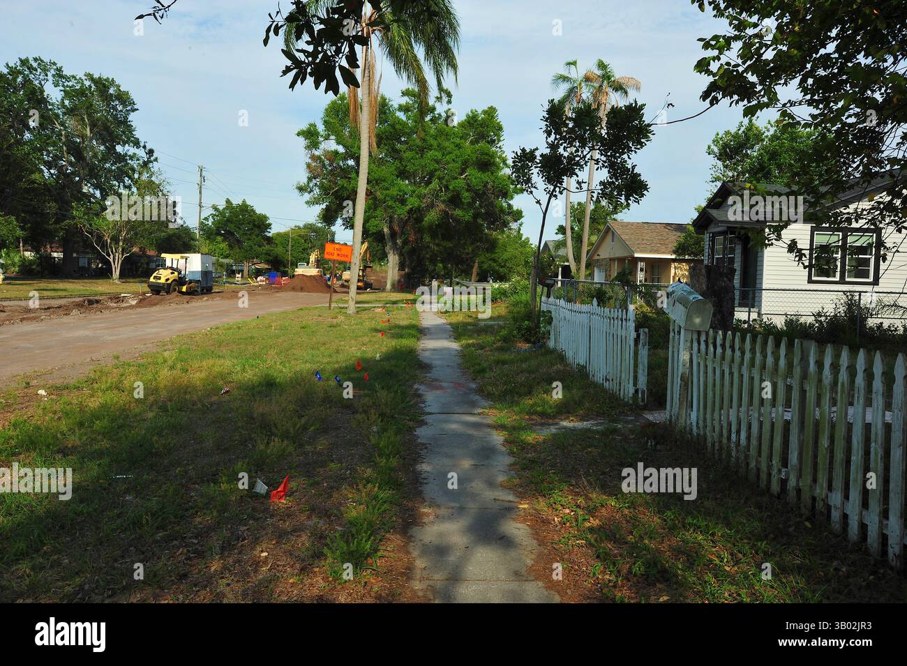 Wide view Road Construction Site with Equipment, Piles of Gravel, and ...