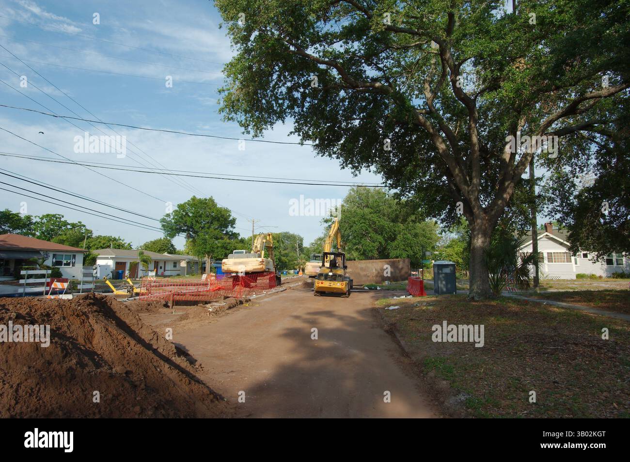 Wide view Road Construction Site with Equipment, Piles of Gravel, and ...