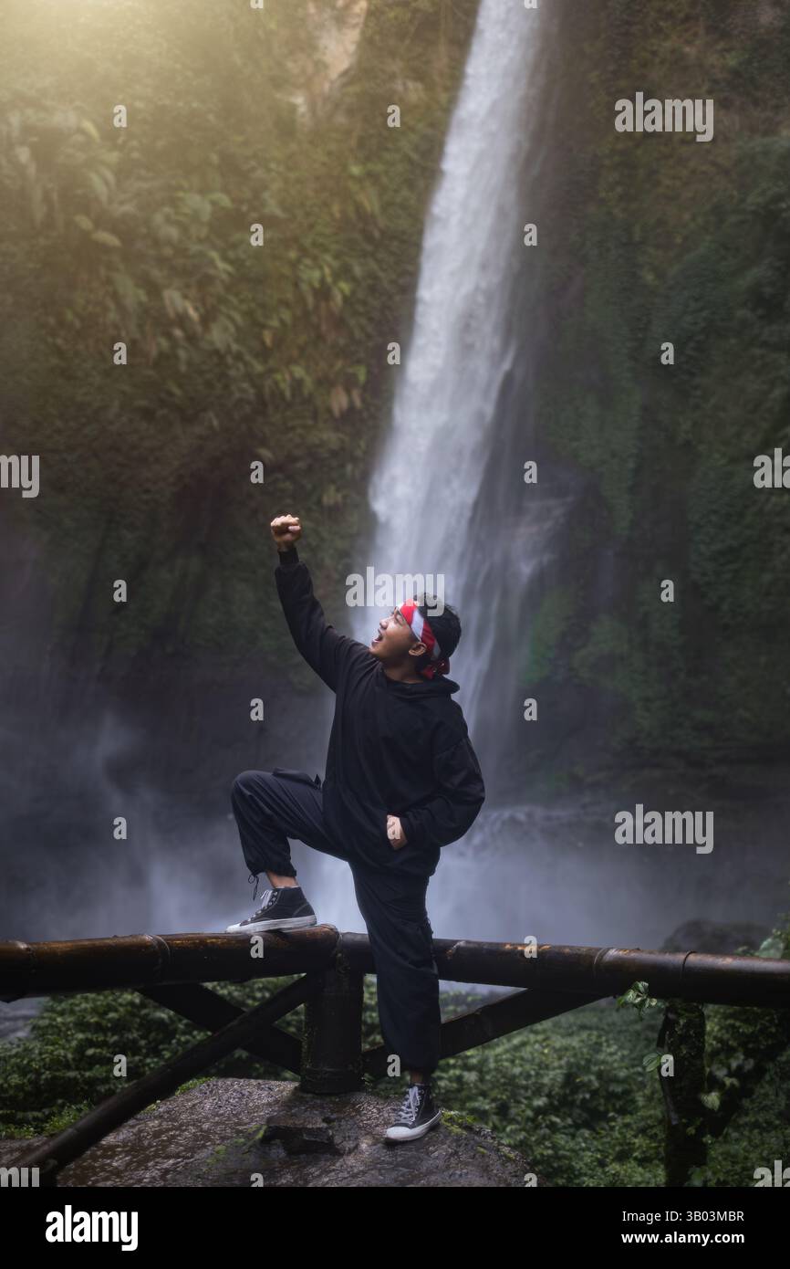 Young Indonesian man celebrating Independence Day with raised fist pose ...