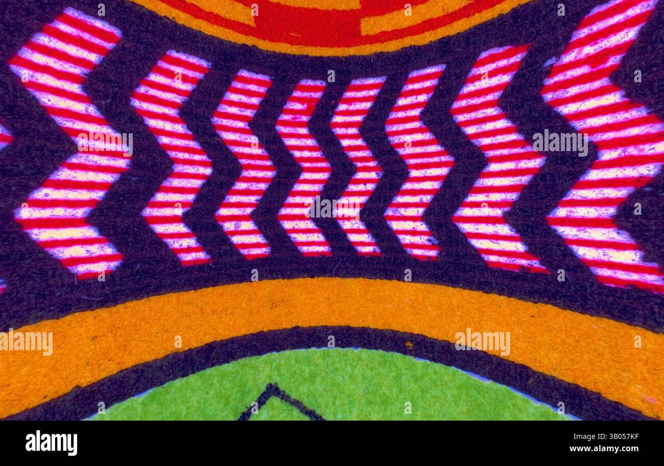 A vibrant geometric pattern features bold stripes and chevron designs in vivid colors, creating ...