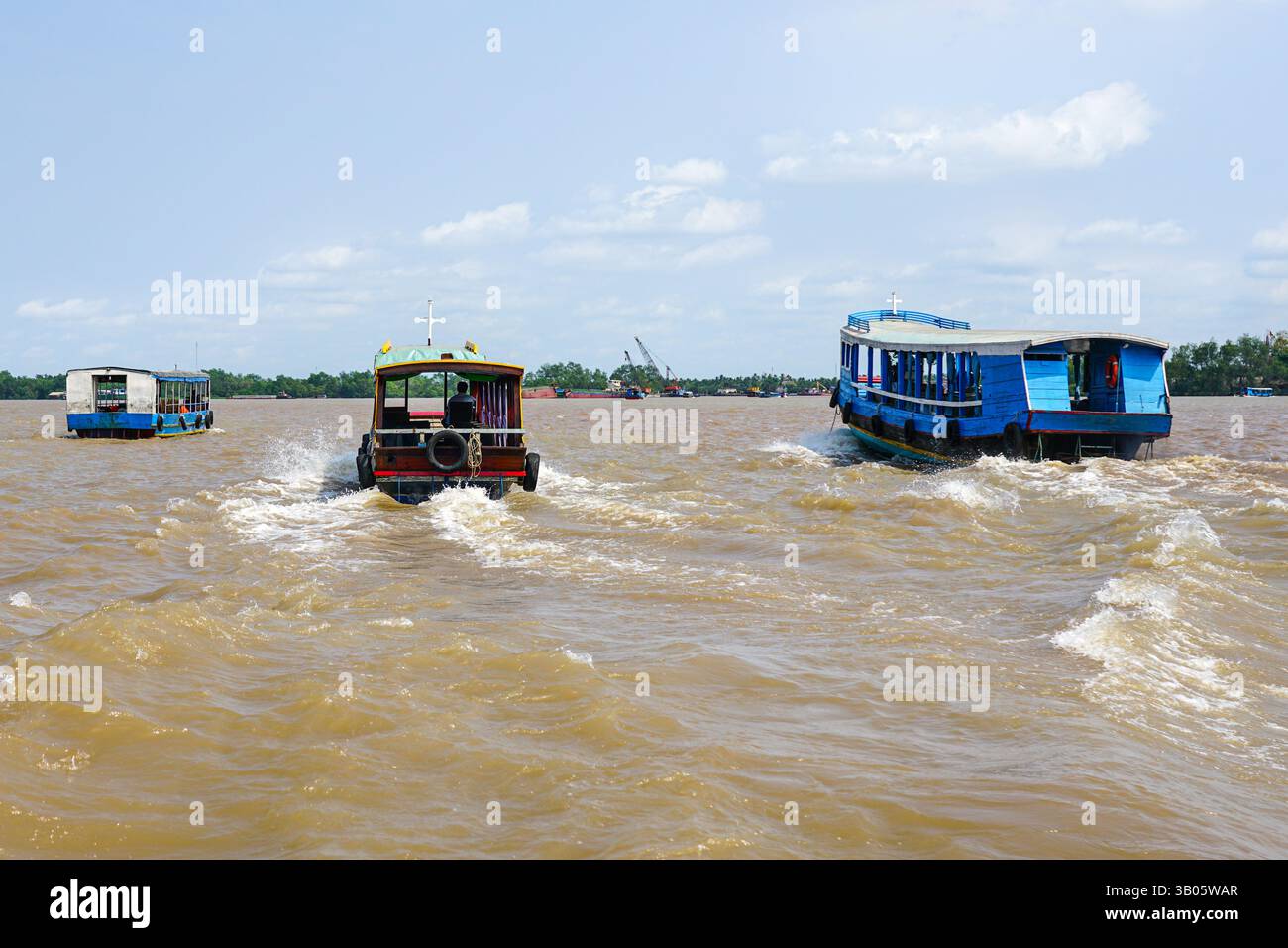 Traditional wooden tourist ferries traffic in the Mekong delta, tourist ...