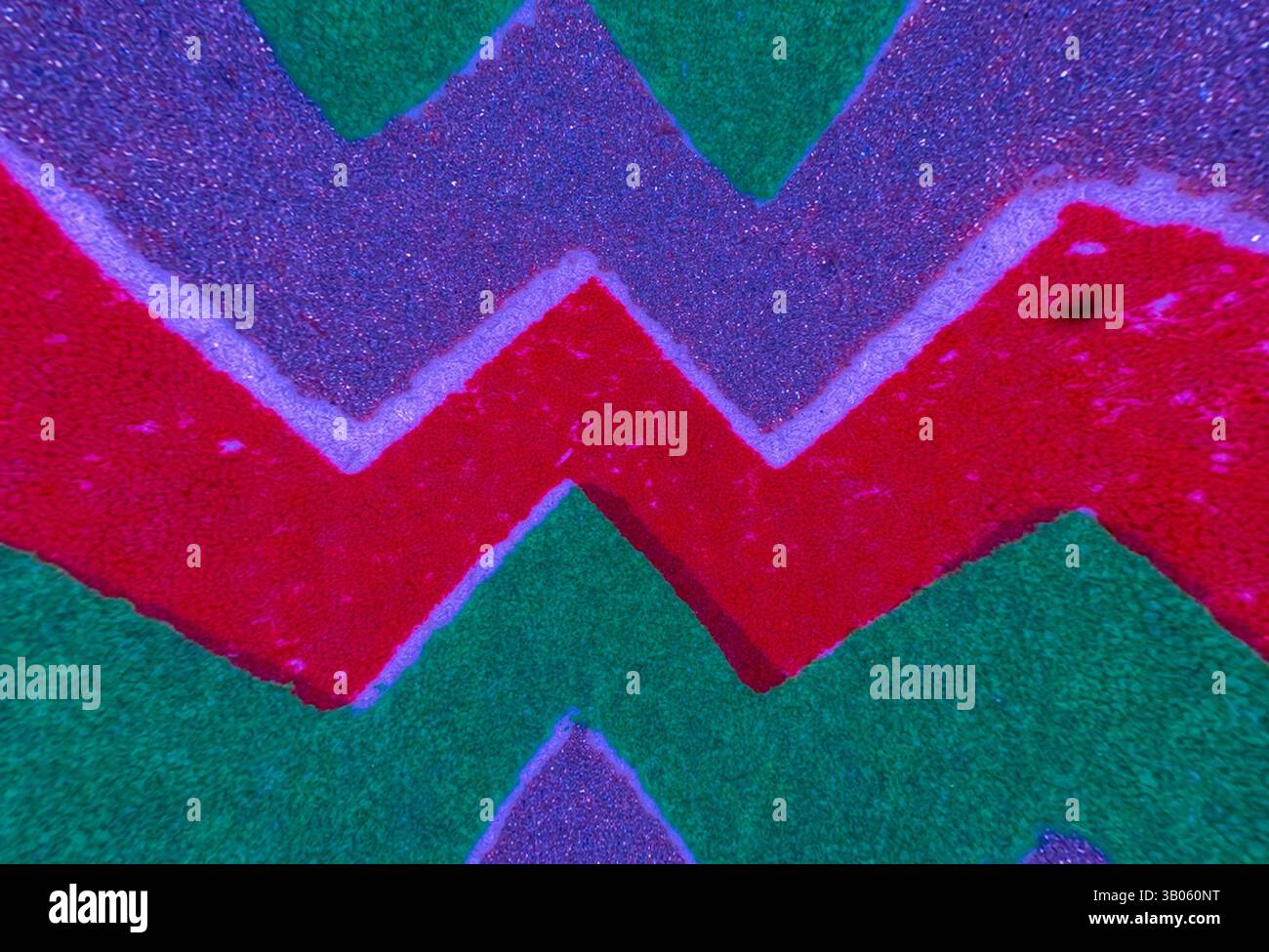 Colorful zigzag patterns in vibrant shades of red, purple, and green create a dynamic and ...