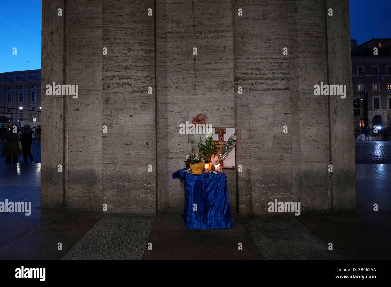 Flowers and candles under a picture of the late Pope Francis as ...