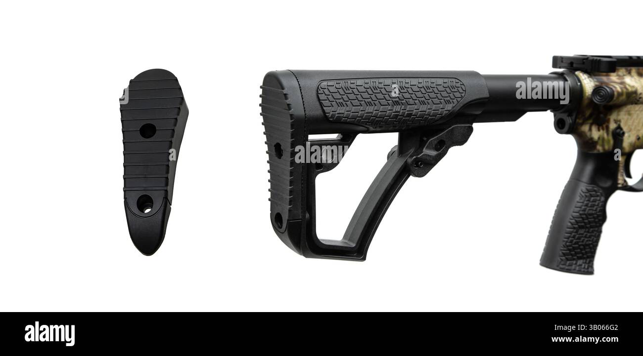 Close-up of a black adjustable rifle stock with textured grip and ...