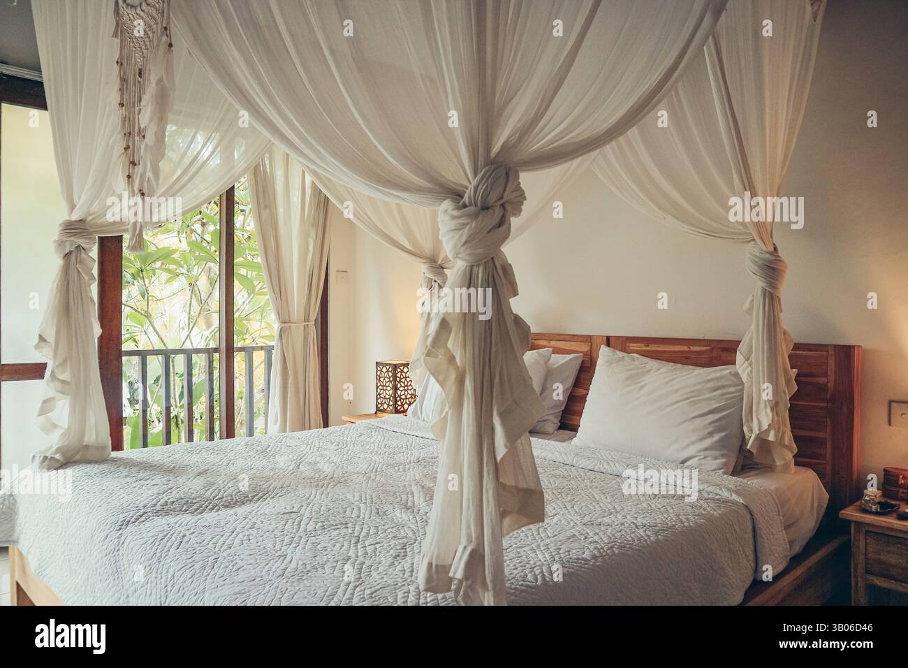 Traditional balinese cozy canopy bed in bedroom Stock Photo - Alamy
