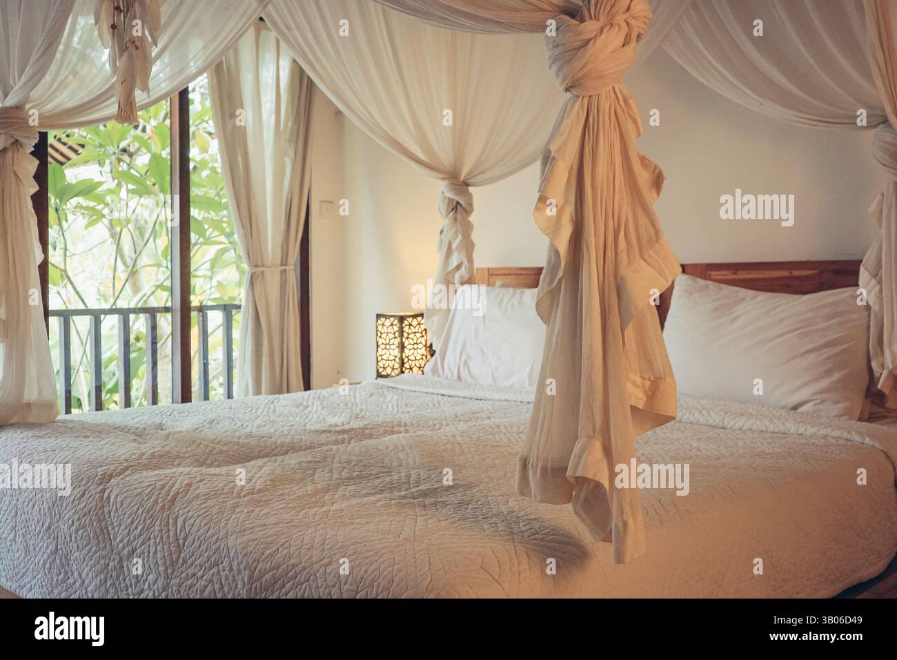 Traditional balinese cozy canopy bed in bedroom Stock Photo - Alamy