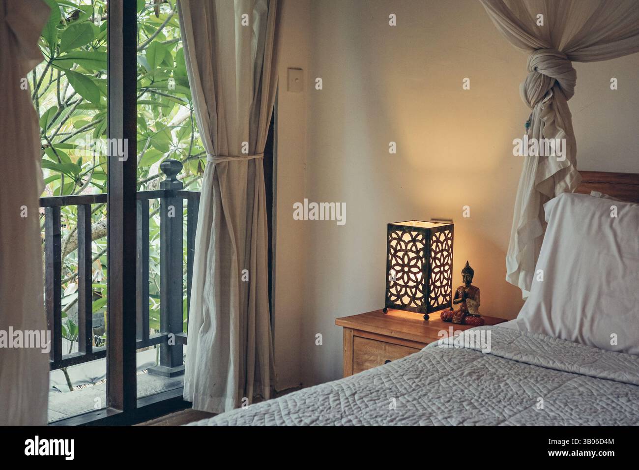 Traditional balinese cozy canopy bed in bedroom Stock Photo - Alamy