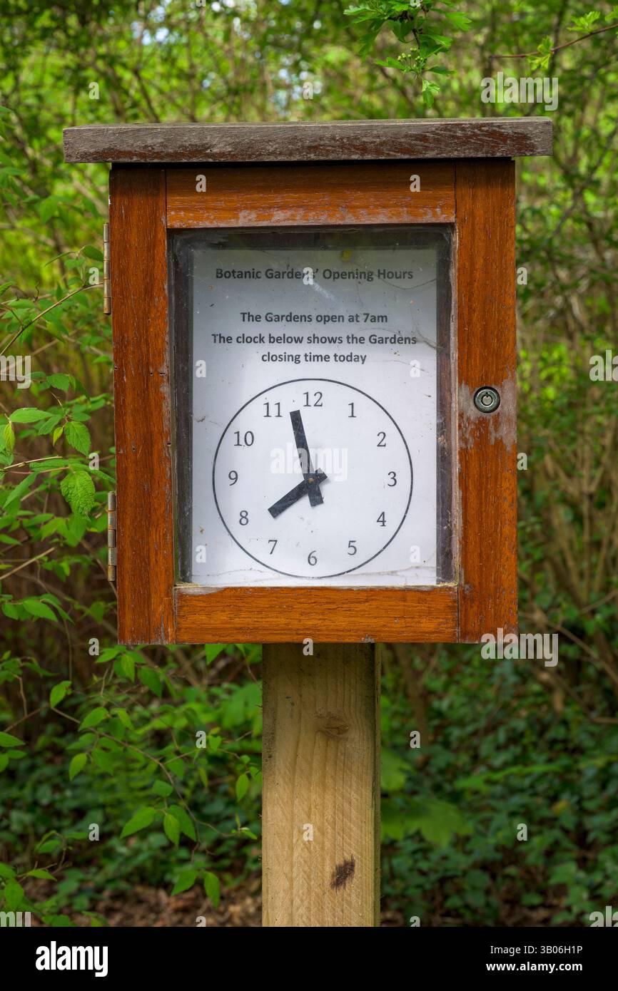Clock displaying the closing and opening time of Botanic Gardens public ...