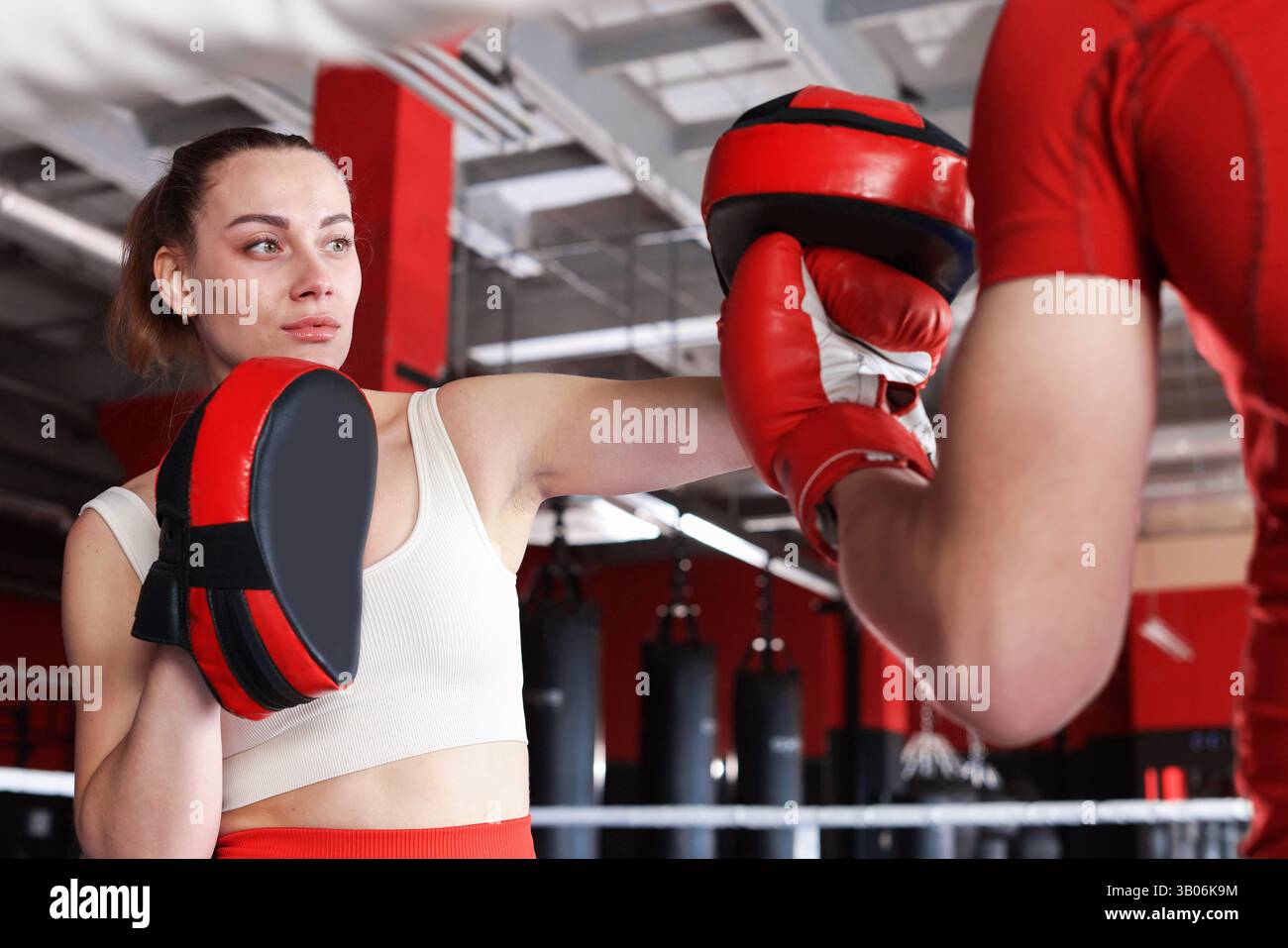 Boxing coach training man in sport center Stock Photo - Alamy