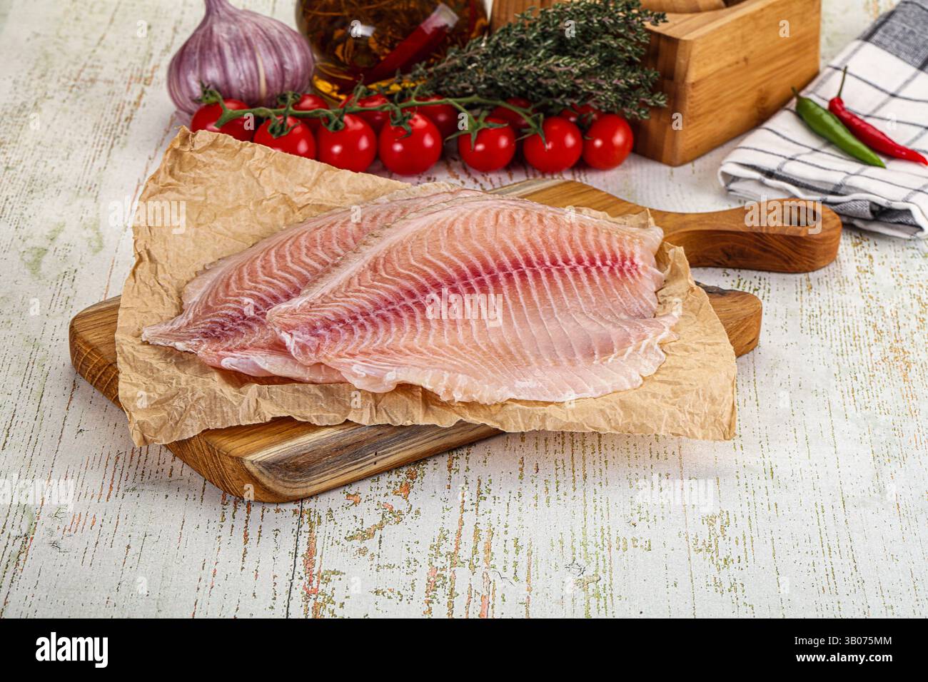 Raw Tilapia fish fillet slice uncooked Stock Photo - Alamy