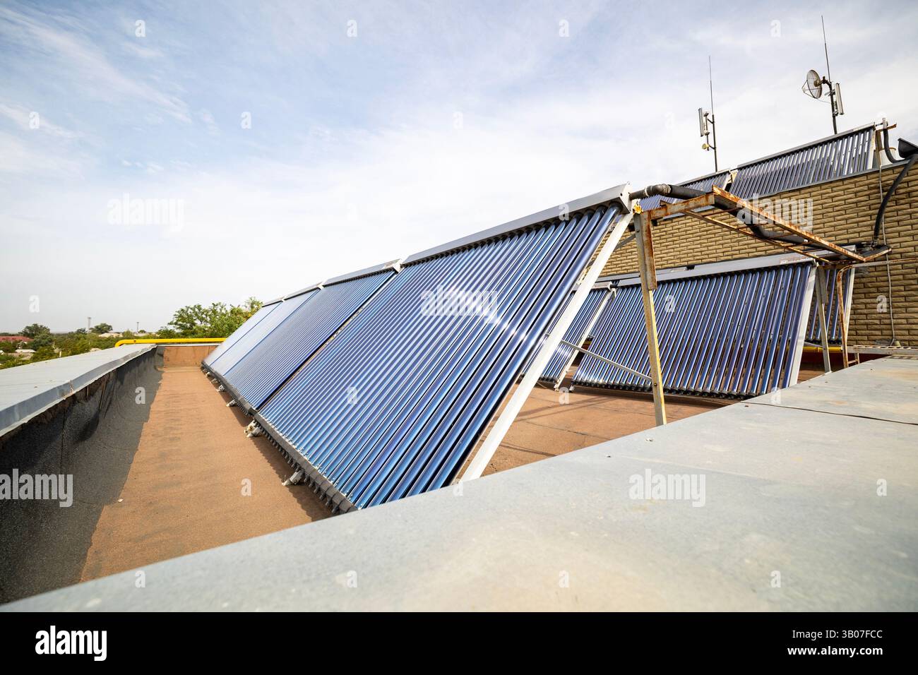 А solar water heating collectors, equipped with blue vacuum tubes, are ...