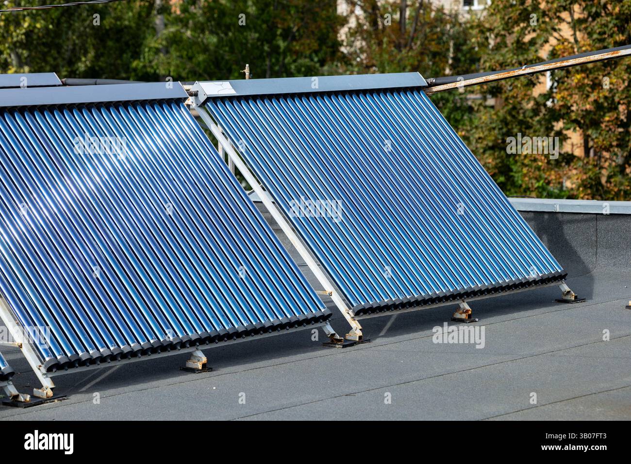 А solar water heating collectors, equipped with blue vacuum tubes, are ...